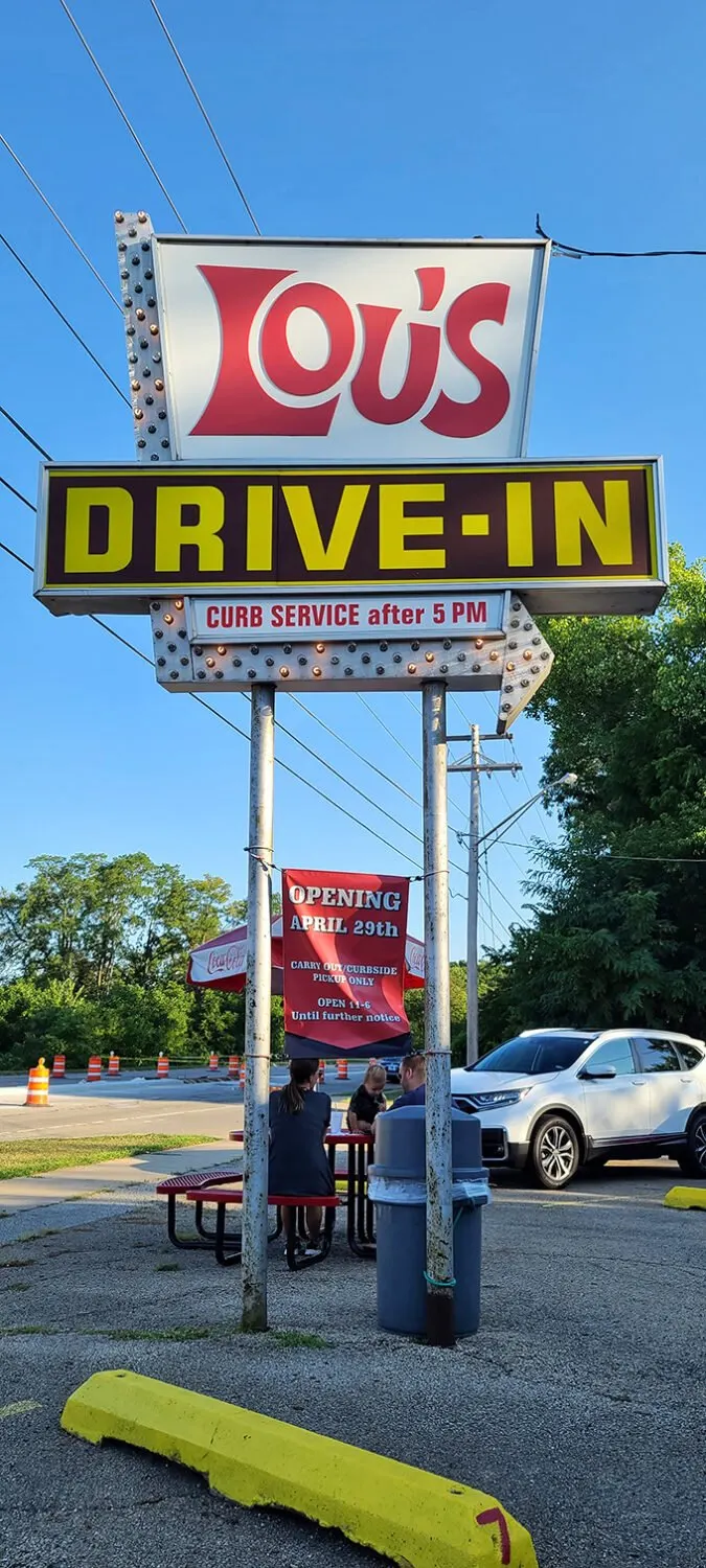 That sign isn't just announcing a restaurant—it's a beacon guiding hungry souls home since before GPS was a thing.