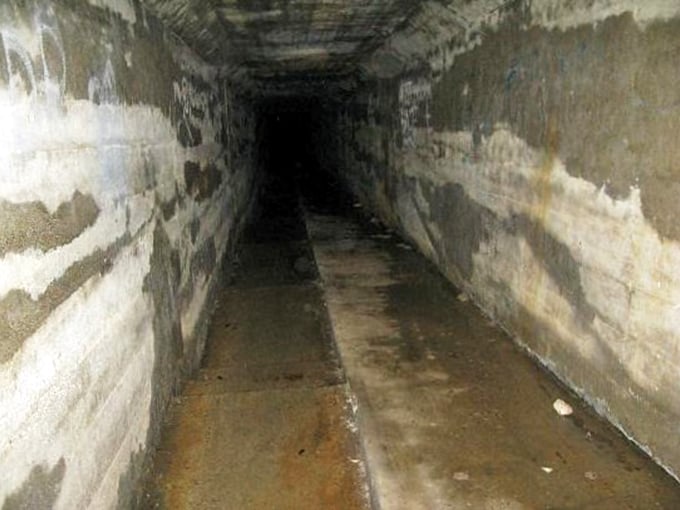 Another view of the Body Chute—its concrete walls have absorbed more sorrow than any structure should bear in a lifetime.