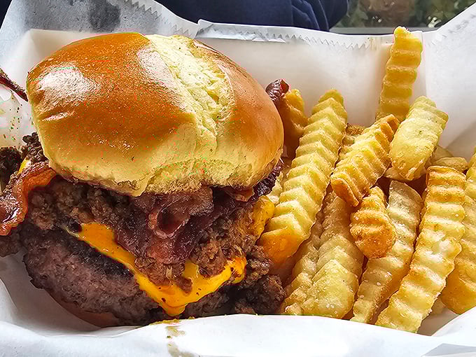 This isn't just a bacon cheeseburger—it's a monument to excess done right. Those crinkle-cut fries are the perfect supporting cast.