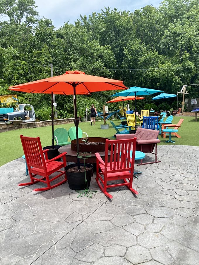 Candy-colored rocking chairs gathered around fire pits – because the best conversations happen when comfort meets crackling flames and cold beverages.