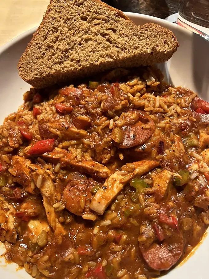 Jambalaya that doesn't hold back—Andouille sausage, chicken, and rice in spicy harmony. The side of beer bread isn't optional, it's essential for sauce-mopping duty.