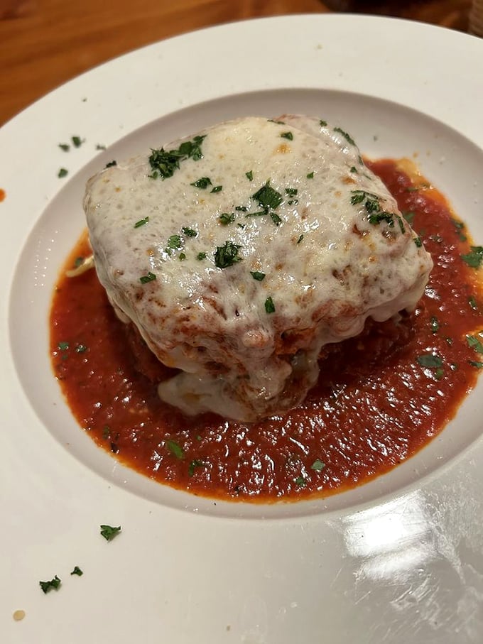 Lasagna that doesn't just sit on the plate—it stands at attention, layers of pasta, cheese, and sauce in perfect harmony.