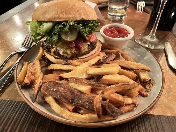 This isn't just a burger—it's a towering achievement of beef architecture. Those hand-cut fries look like they're auditioning for a food magazine cover.