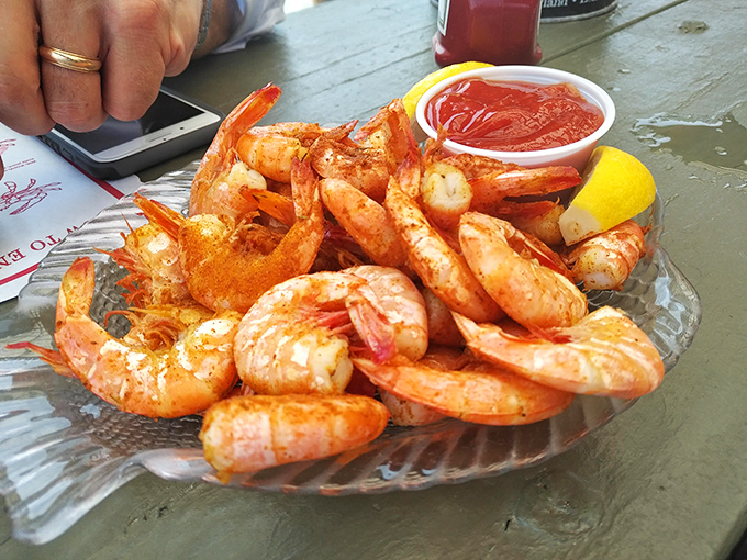 Plump shrimp that practically snap when you bite them—the perfect finger food for waterfront dining. That cocktail sauce isn't just red; it's a flavor alarm.