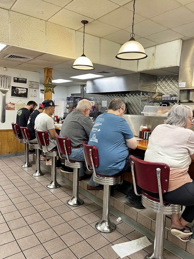 The counter seats – breakfast's front-row tickets – where regulars watch the morning ballet of spatulas and coffee pots with appreciative eyes.