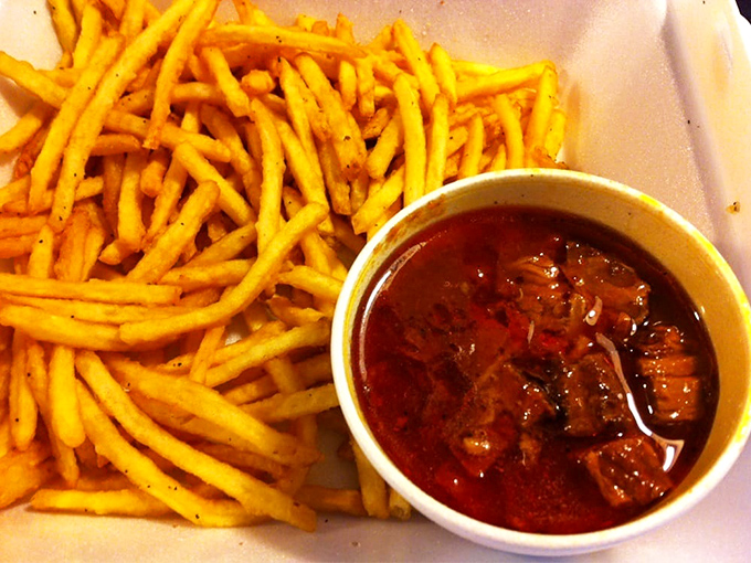 Golden fries alongside that legendary burnt end chili—a partnership more perfect than Astaire and Rogers. The ideal vehicle for sopping up every last drop.