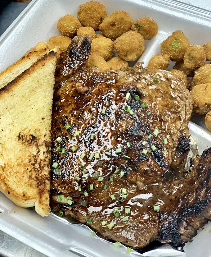 This isn't just steak – it's a carnivore's dream, glistening with savory promise and paired with golden-fried okra that grandma would approve.