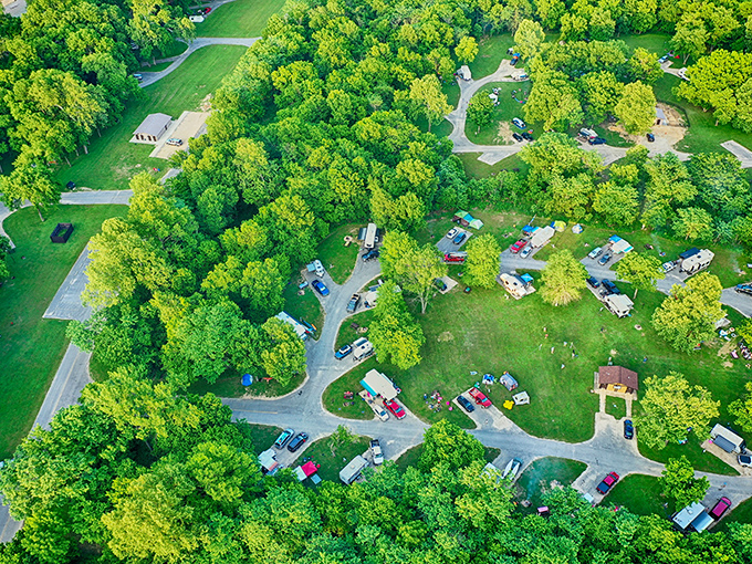 An aerial view reveals how perfectly the campground nestles into the forest – human presence in harmony with nature, not fighting against it.