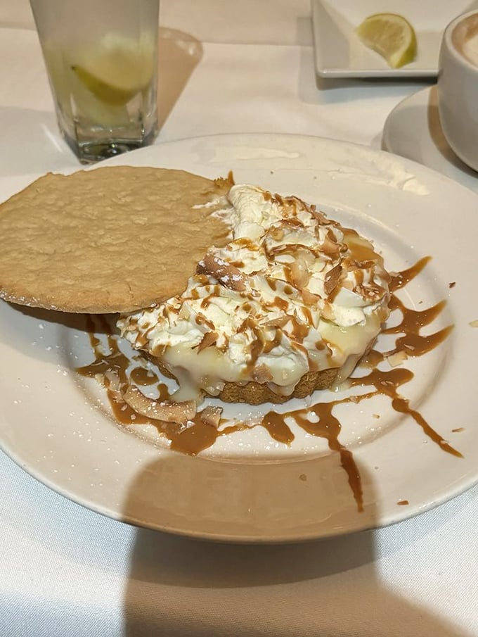 This isn't just dessert – it's architecture with a purpose. The golden cookie crown commands respect before surrendering to your spoon.