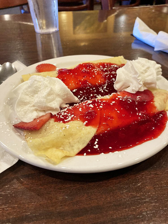 A delicate crepe adorned with berries and cream—proof that breakfast can be both a feast for the eyes and a celebration for the taste buds.