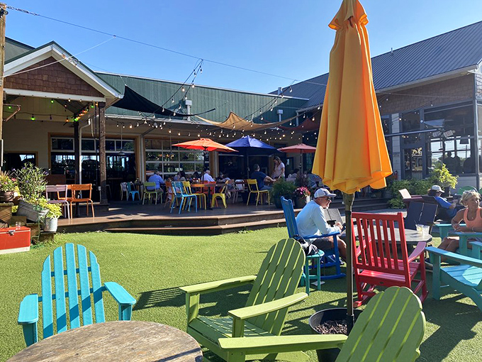 A backyard fantasy come to life – where Adirondack chairs in Crayola colors invite you to sink in, sip slowly, and forget what day it is.