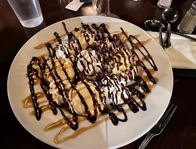 A dessert worth saving room for—or ordering a second stomach. Caramel and chocolate drizzles turn this into an edible work of art.