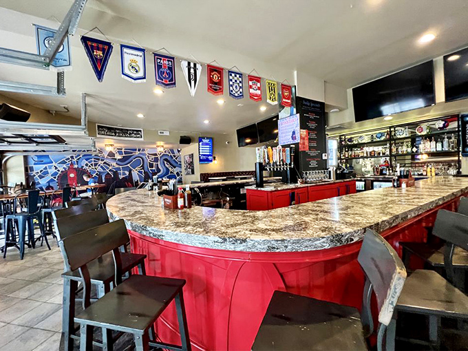 The bar area, complete with soccer pennants, where pints are poured with reverence and strangers quickly become friends over shared sports allegiances.
