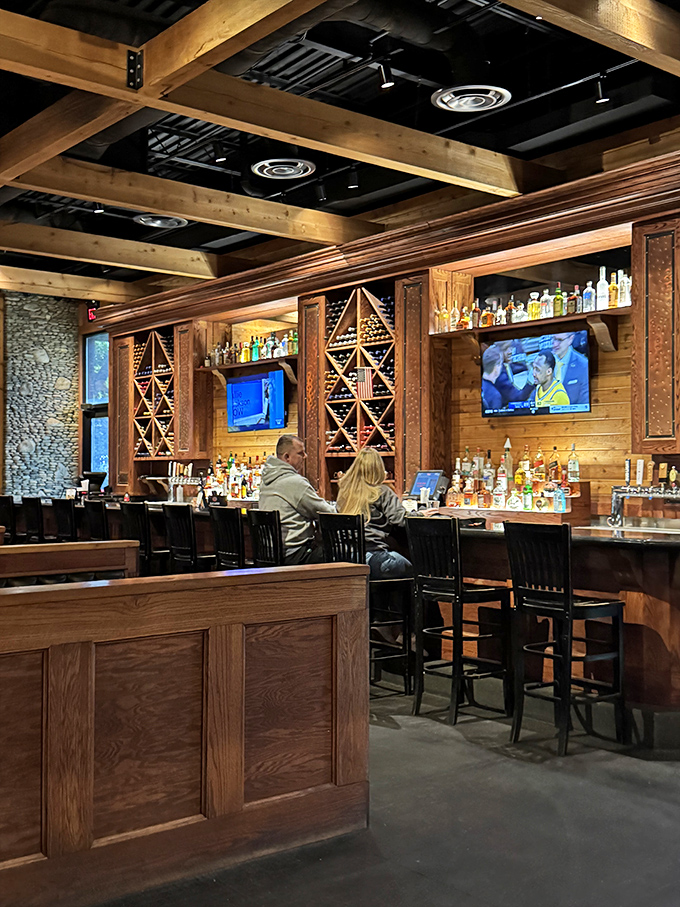 A bar that says "pull up a stool and stay awhile" without saying a word. Those wooden wine racks aren't decoration—they're a promise of good times ahead.