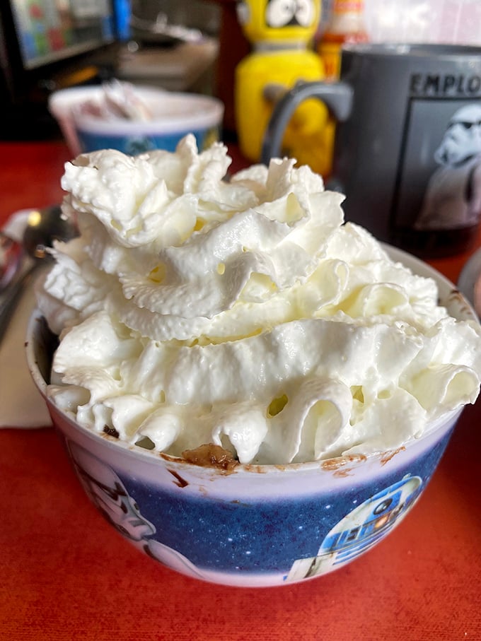 Cloud City has nothing on this towering mountain of whipped cream atop what appears to be a heavenly bread pudding in a themed bowl.