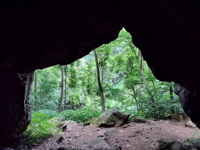 Peering out from this natural cave feels like looking through a portal to another world, framed by ancient rock that's been waiting millennia for your arrival.