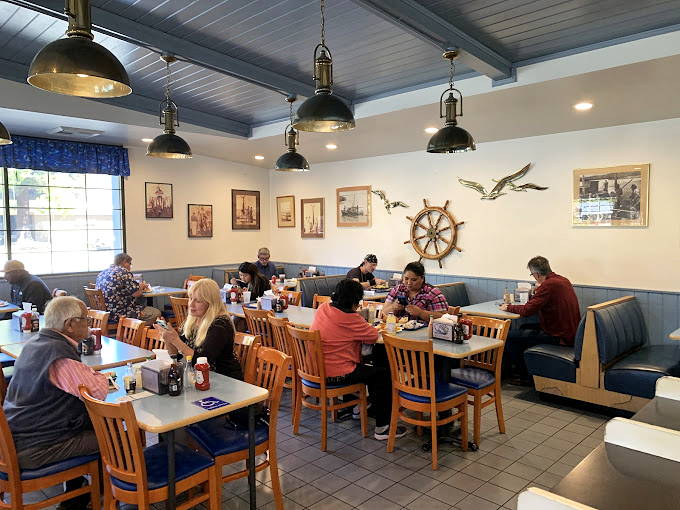 The dining room hums with the satisfied murmurs of people who've discovered what seafood is supposed to taste like. Those nautical decorations aren't kitsch—they're earned.
