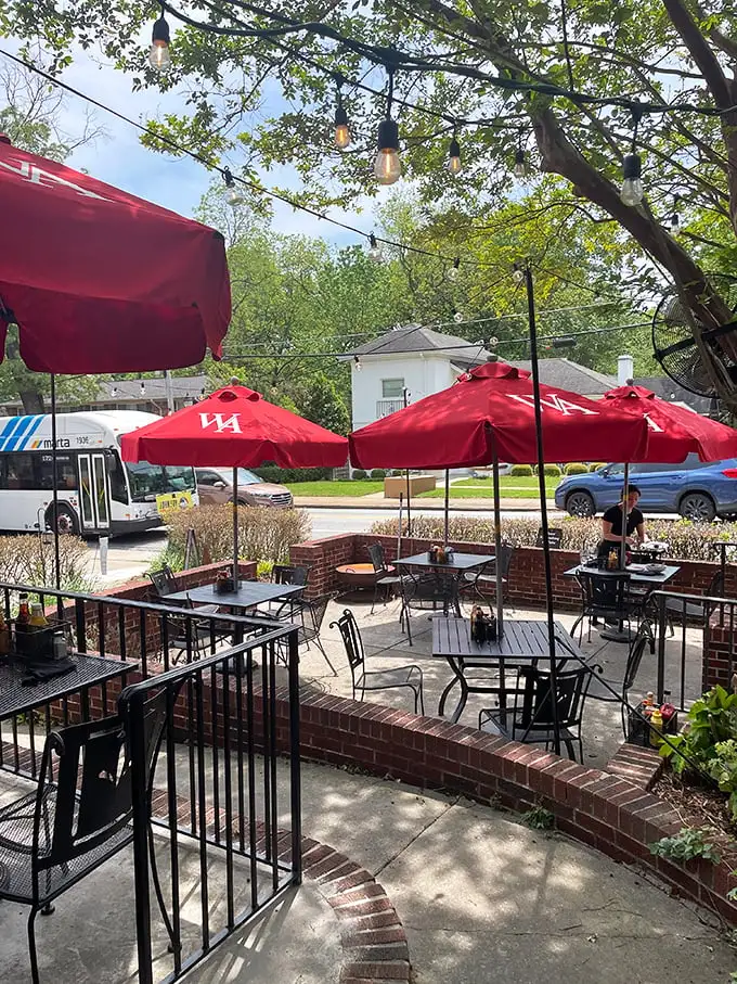 The patio offers alfresco dining beneath string lights and cherry-red umbrellas. A little slice of British pub culture under Georgia's sunny skies.