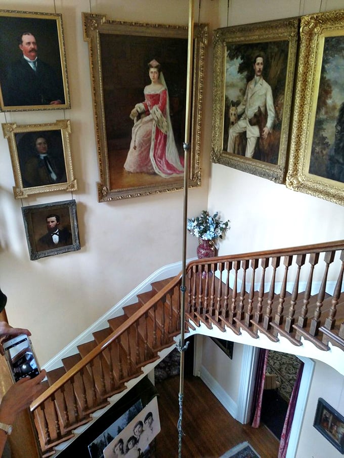 The grand staircase showcases a dynasty in oil paints, where generations of formal portraits remind us that Instagram filters aren't the first way we've tried to look our best.