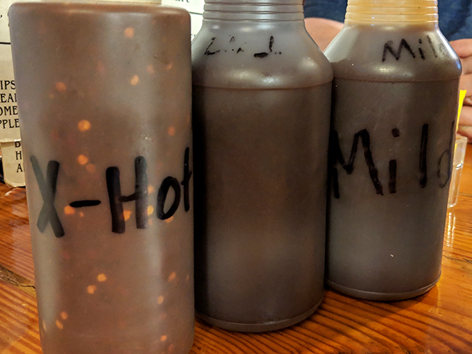 Sauce bottles labeled with delicious simplicity. In the barbecue world, these aren't condiments—they're liquid personality profiles for your meat.