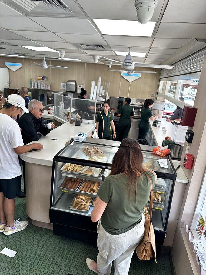 The ventanita (little window) serves democracy in a tiny cup—where CEOs and construction workers stand shoulder to shoulder for liquid rocket fuel.