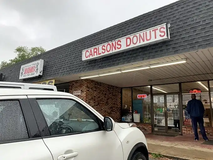 Carlson's Donuts exterior – where the no-frills brick façade hides Maryland's unsung hero of fried dough. A glorious sugar sanctuary in strip mall disguise.