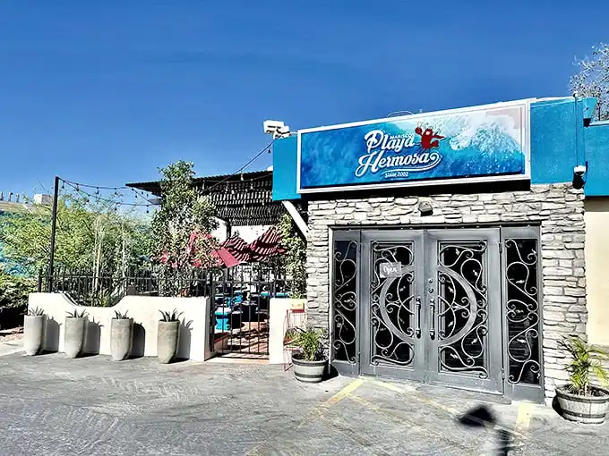 Palm trees and string lights create the perfect backdrop for enjoying Playa Hermosa's fresh seafood—like finding a coastal oasis in Phoenix.
