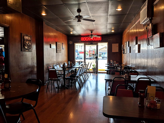 Wood-paneled walls and that glowing "ROCKHOUSE" sign create the perfect backdrop for carnivorous adventures. No designer needed when you've got decades of character.