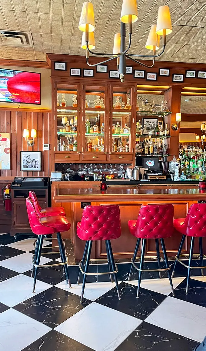 The bar at The Avenue isn't just gorgeous—those red leather stools are practically begging you to settle in for a Manhattan and life-changing conversation.