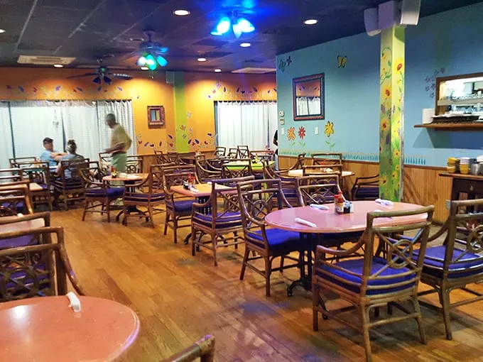 Bright blue walls and bamboo chairs create the perfect canvas for comfort food artistry. This isn't just decor—it's a mood enhancer.
