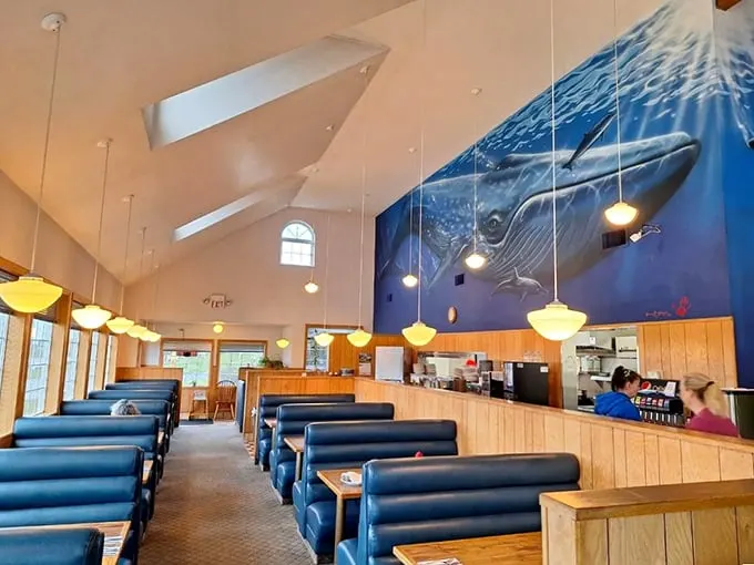 Navy blue booths and warm wood paneling create the perfect maritime-meets-cozy atmosphere, where breakfast dreams come true.
