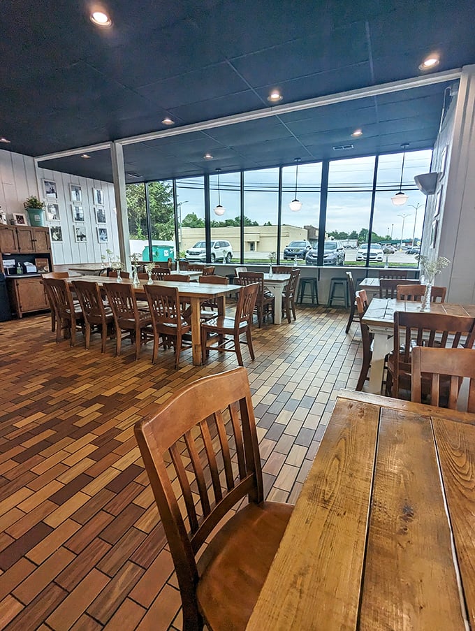 A bright, airy interior with wooden tables and chairs creates the perfect backdrop for ice cream memories. That brick floor has witnessed countless "first lick" smiles.