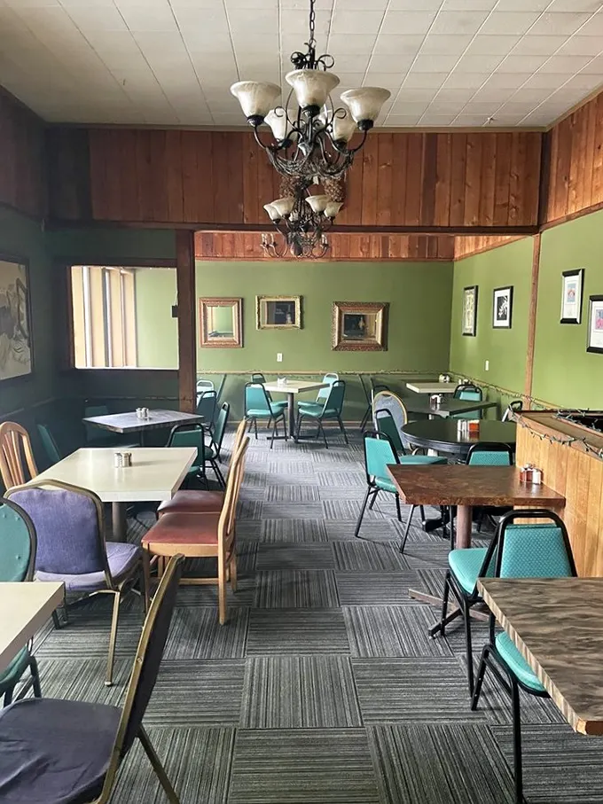 Mint green walls, wooden accents, and vintage chandeliers create that rare atmosphere that's both cozy and slightly elegant—like wearing good shoes with sweatpants.