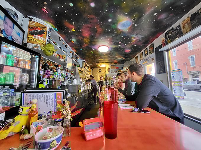 Dining under the stars isn't just a saying here—the cosmic ceiling transforms your lunch into an interstellar adventure while patrons enjoy their galactic grub.