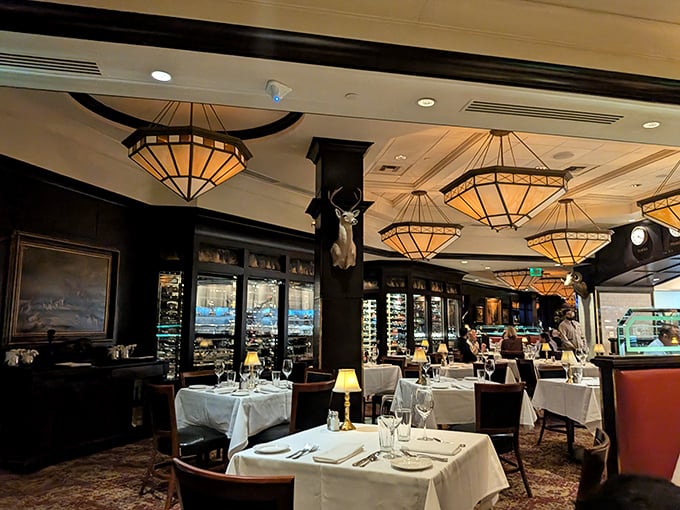 Warm amber lighting cascades from geometric chandeliers while polished wood creates an atmosphere where even James Bond wouldn't mind waiting for his martini.