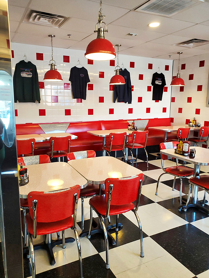 Red booths, checkered floors, and pendant lights create the diner trifecta of perfection—like walking into a Norman Rockwell painting that serves coffee. 