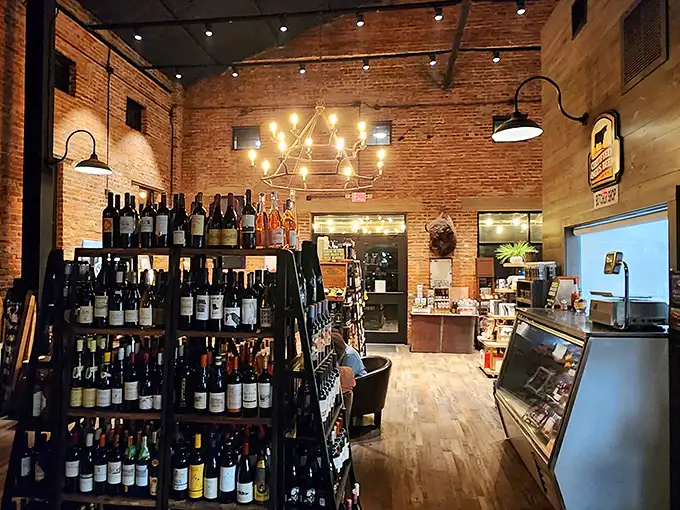 Wine bottles stand at attention like soldiers guarding liquid treasures. The rustic brick interior creates the perfect backdrop for an evening of culinary indulgence.
