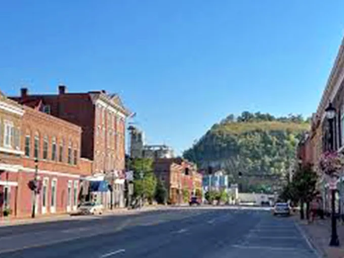 Main Street stretches toward Barn Bluff like a red-brick runway, where historic architecture meets natural splendor in perfect Minnesota harmony.