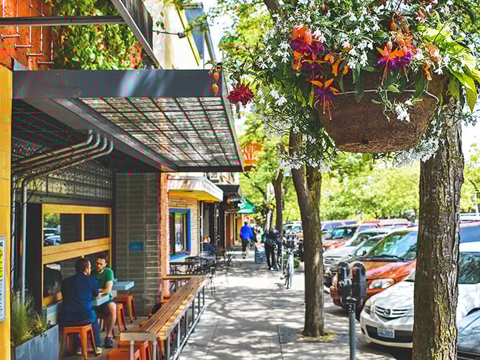 Sidewalk dining under hanging flower baskets – where the Pacific Northwest's famously good weather isn't just a myth, it's lunch policy.