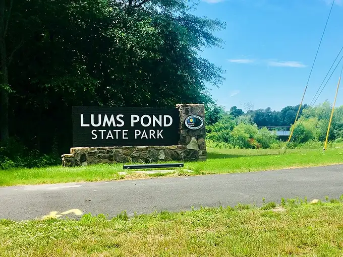 The gateway to adventure doesn't need neon lights. This stone and wood entrance sign promises exactly what it delivers—pure outdoor bliss.