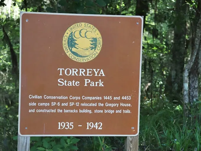 A humble brown sign tells an extraordinary story. The CCC's 1930s craftsmanship still welcomes visitors to this Florida anomaly nearly a century later.