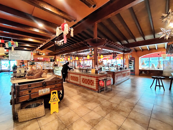 Step inside and the transformation is complete—wooden beams, colorful papel picado, and display cases that make adults press their noses against glass like excited children. 