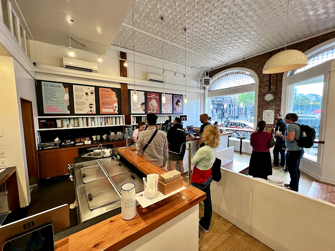 Ice cream democracy in action – patrons ponder life's most important decision while the minimalist interior keeps the focus where it belongs: on your next scoop.