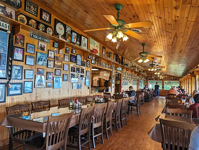 Wall-to-wall memories line this wood-paneled dining room, where every framed photo tells a story and every table promises a view.