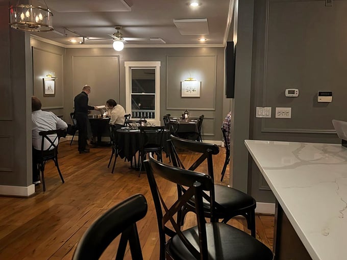 Elegant simplicity at its finest. Gray walls, wooden floors, and tasteful artwork create the perfect backdrop for the real star—what's about to arrive on your plate.
