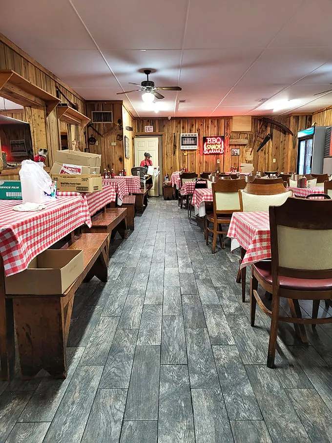 Classic red-and-white checkered tablecloths and wood-paneled walls create the perfect backdrop for barbecue bliss. This isn't décor—it's a promise of authenticity.