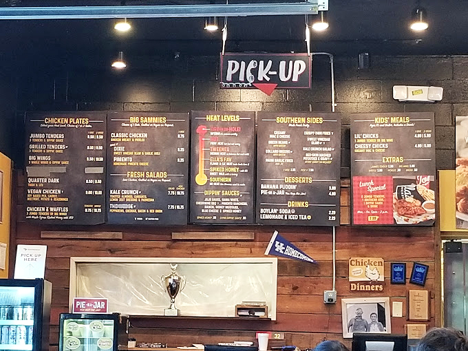 That menu board isn't just listing food—it's mapping out your journey from "Southern" (for spice novices) to "Fire-In-Da-Hole" (for those who laugh in the face of capsaicin).