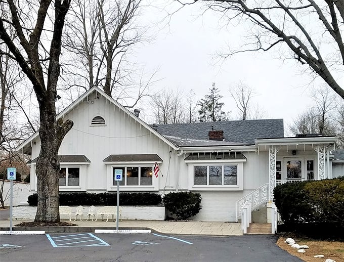 Hollyhock Hill's charming white cottage exterior is the culinary equivalent of a warm hug from grandma.