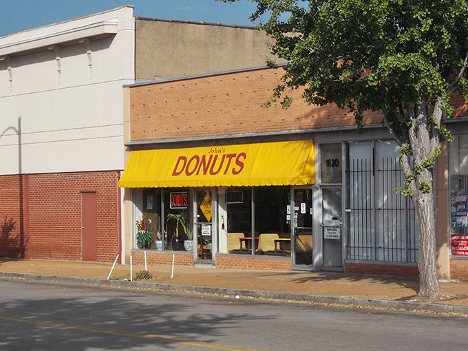 That sunshine-yellow awning isn't just cheerful – it's a beacon for serious donut lovers seeking authenticity in every bite.