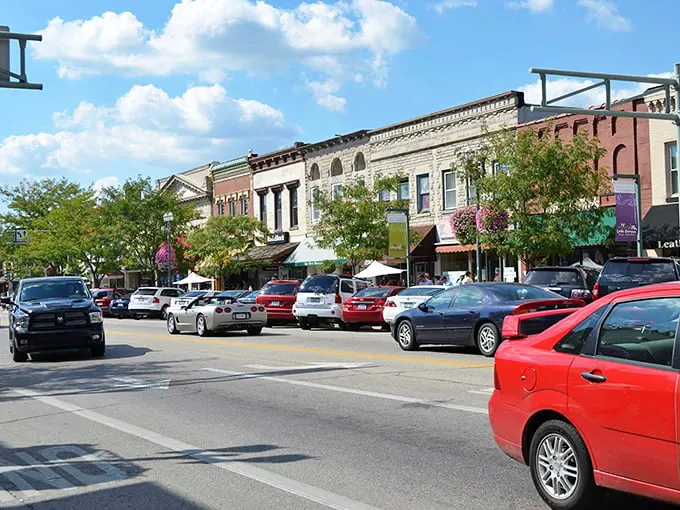 Historic buildings line Lake Geneva's bustling downtown, where window shopping becomes an Olympic sport for visitors and locals alike.